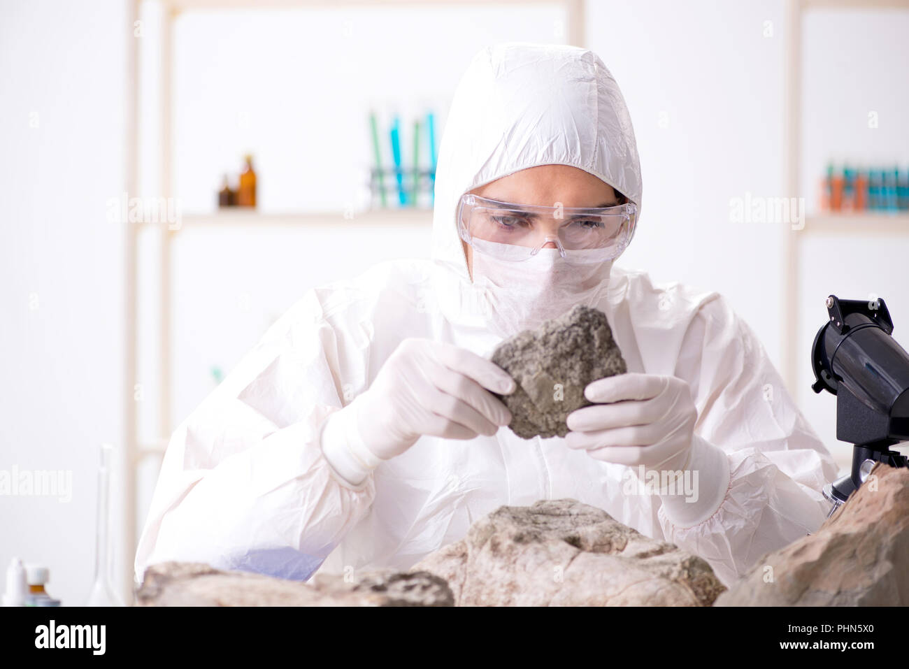 Scientist looking and stone samples in lab Stock Photo - Alamy
