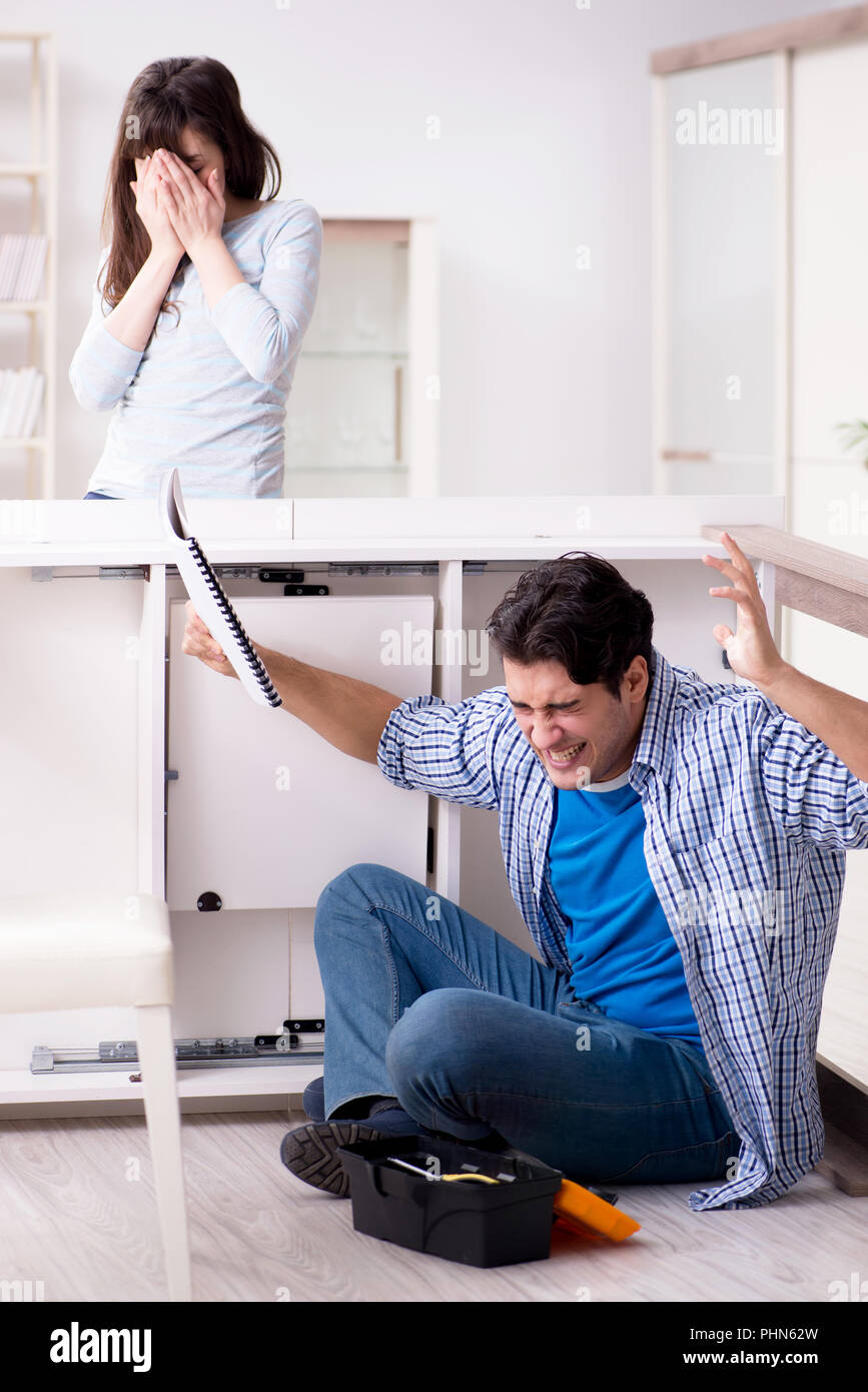 Husband repairing broken table at home Stock Photo - Alamy