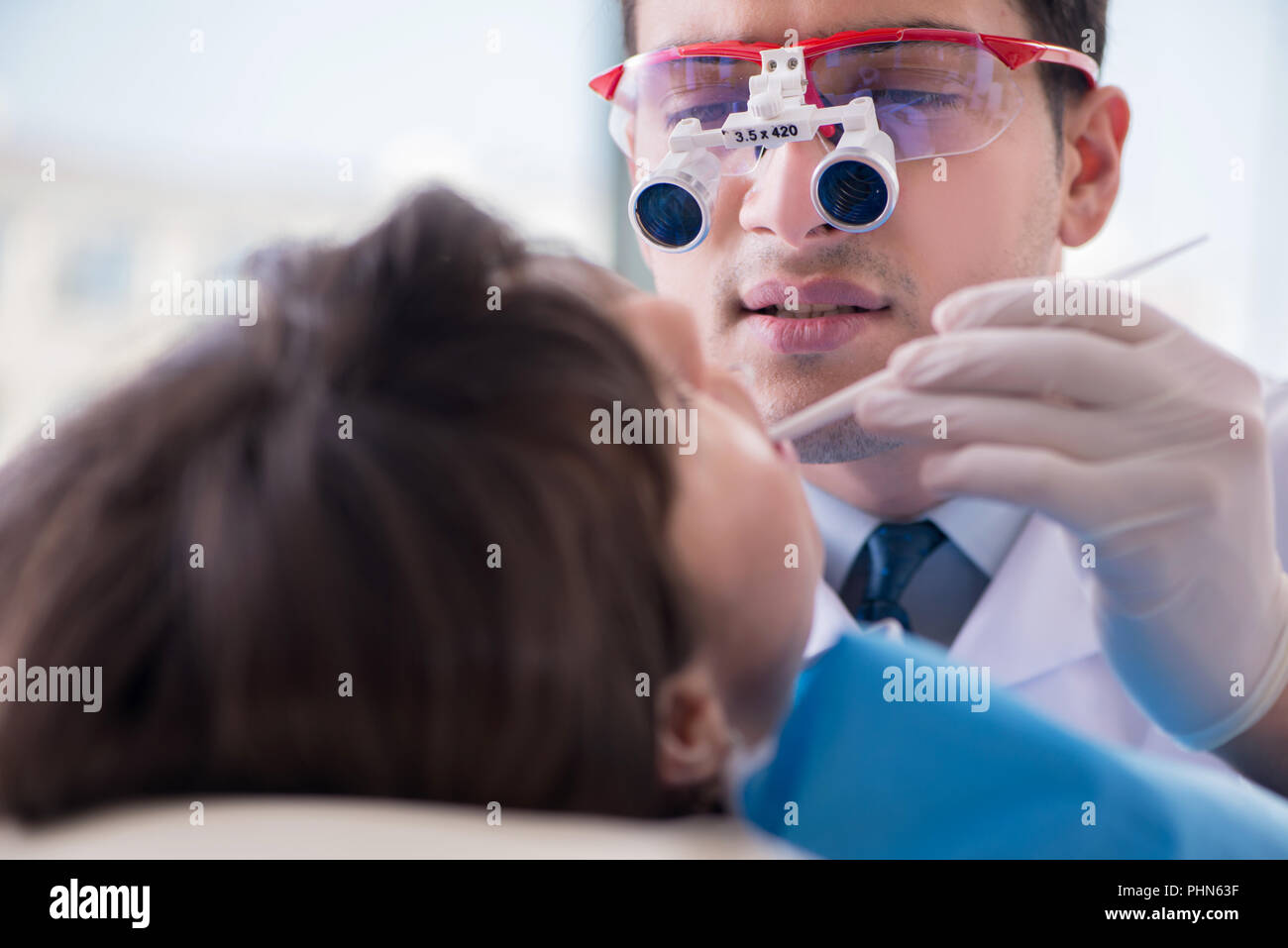 Patient visiting dentist for regular check-up and filling Stock Photo ...