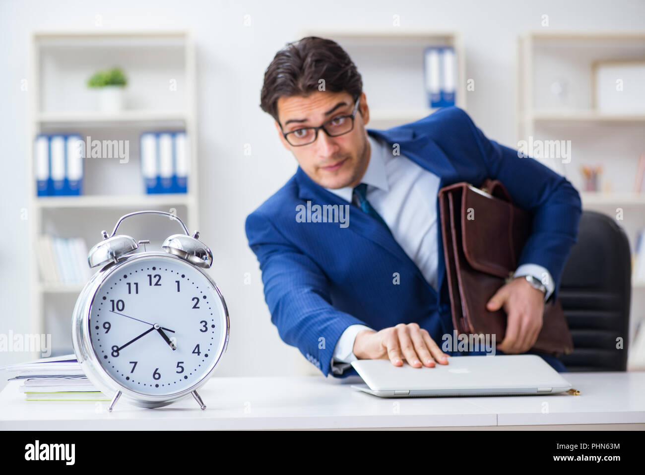 Businessman in bad time management concept Stock Photo - Alamy