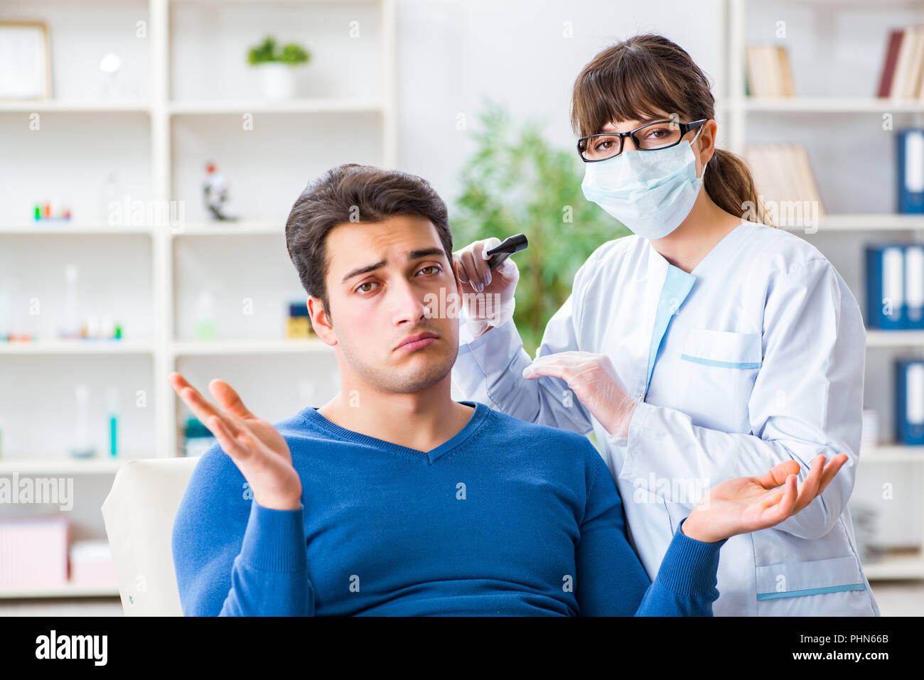 Doctor checking patients ear during medical examination Stock Photo - Alamy