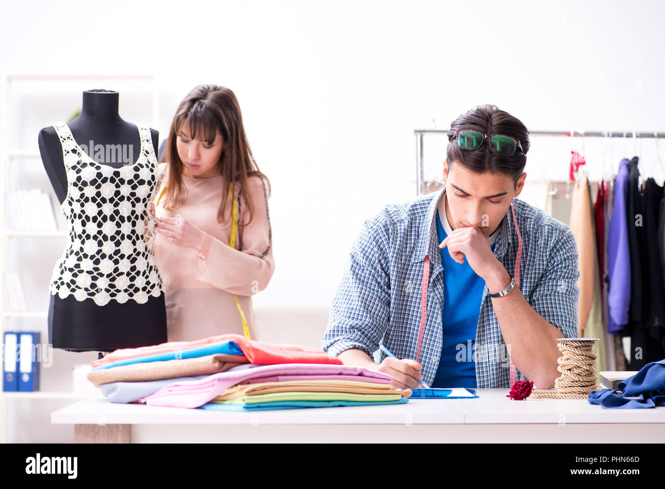 Male tailor with female student in workshop Stock Photo - Alamy
