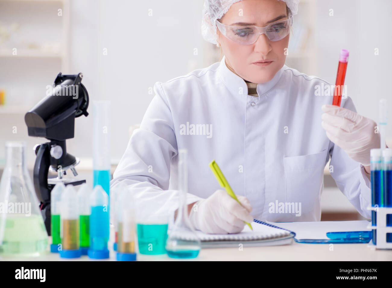 Woman doctor checking blood samples in lab Stock Photo - Alamy