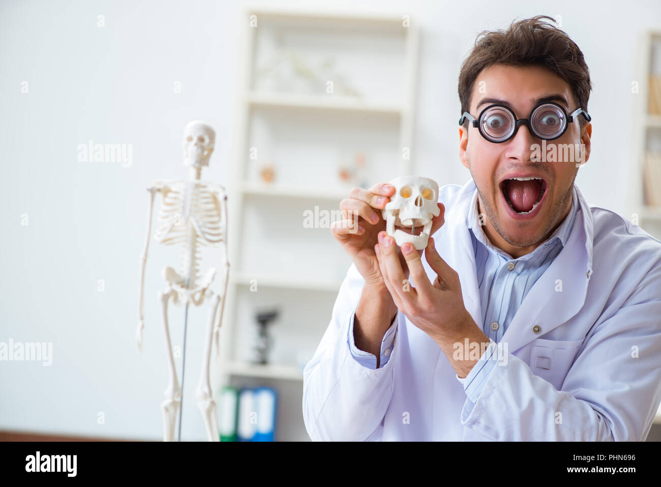 Crazy doctor studying human skeleton Stock Photo - Alamy
