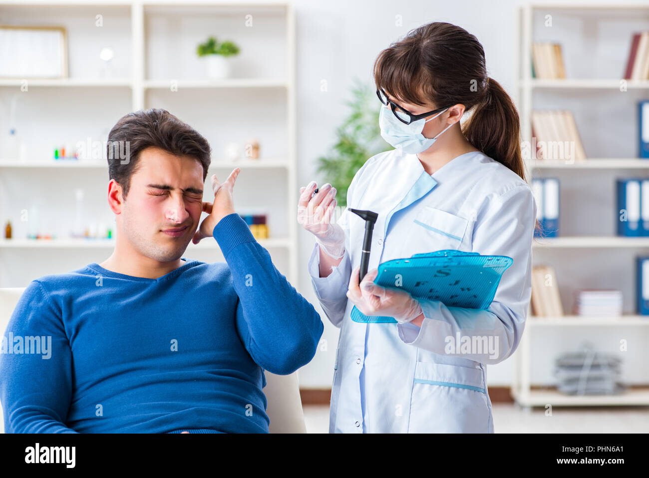Doctor checking patients ear during medical examination Stock Photo - Alamy