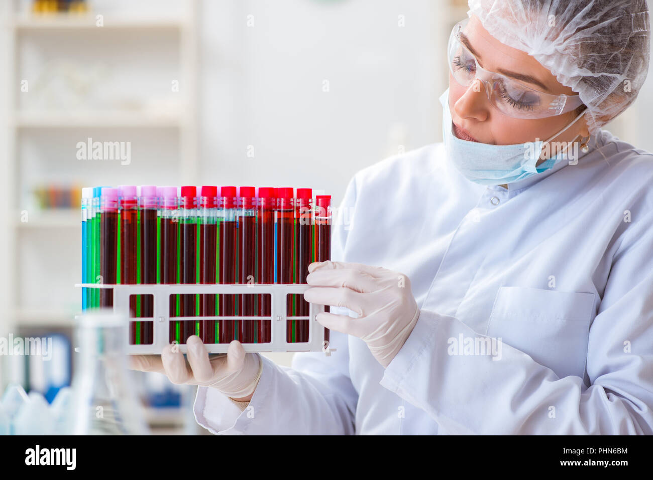 Woman doctor checking blood samples in lab Stock Photo - Alamy