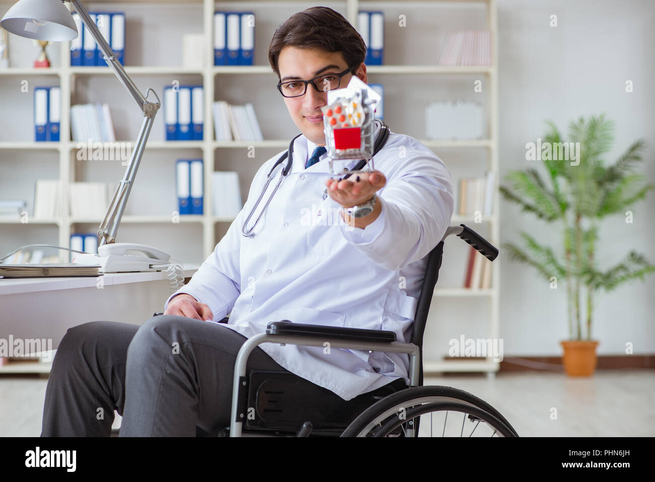 Disabled doctor on wheelchair working in hospital Stock Photo - Alamy