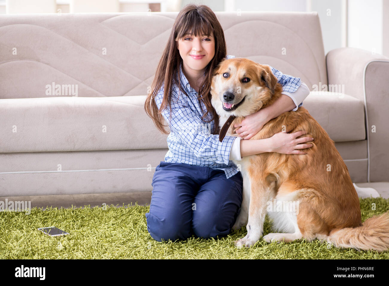 Happy woman dog owner at home with golden retriever Stock Photo - Alamy
