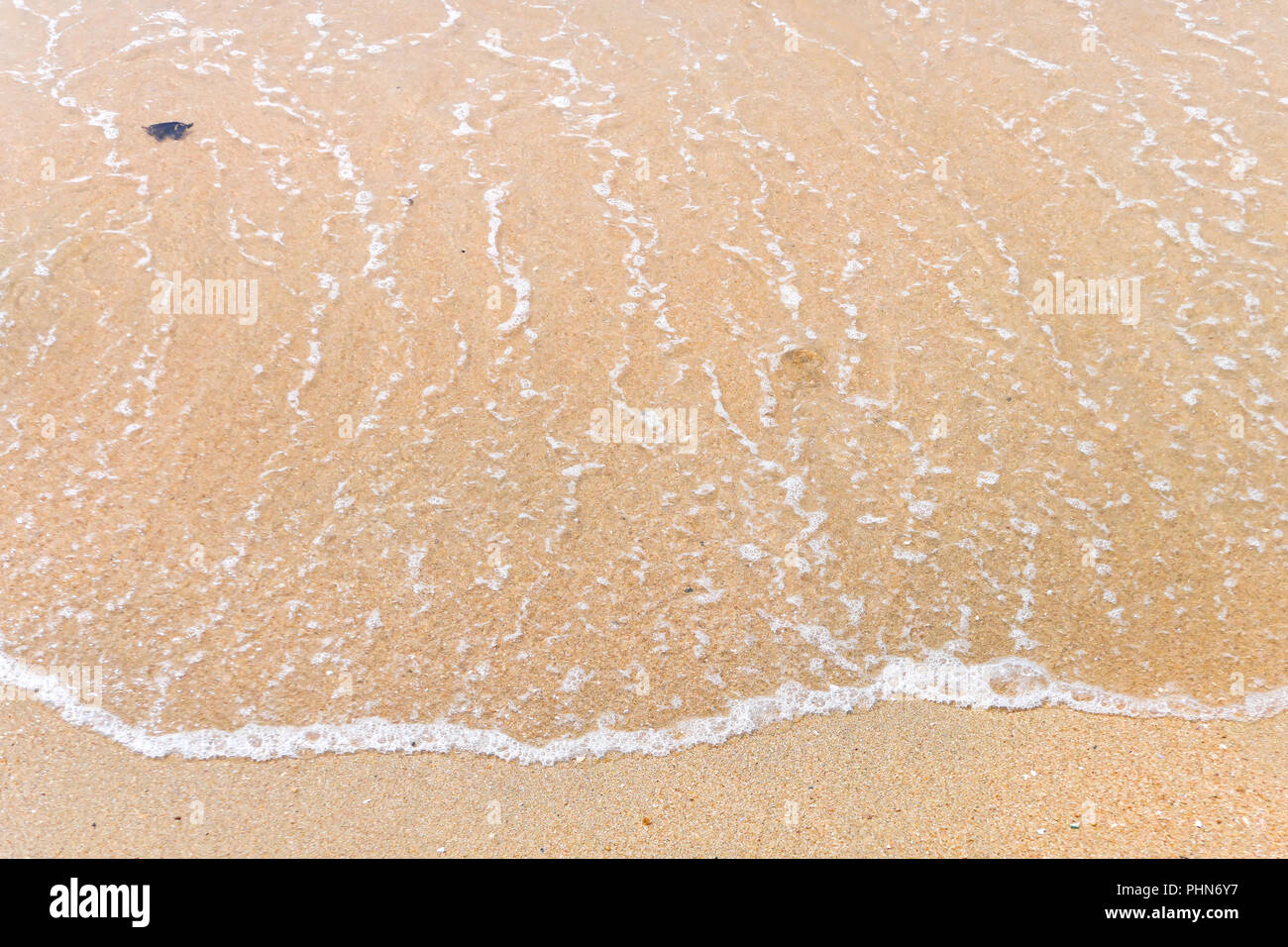 Wave on sand Stock Photo - Alamy