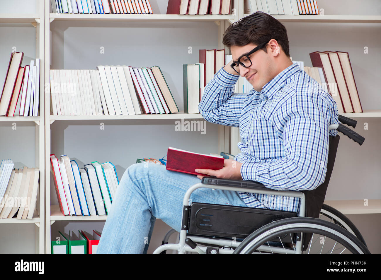 Disabled student studying in the library Stock Photo - Alamy