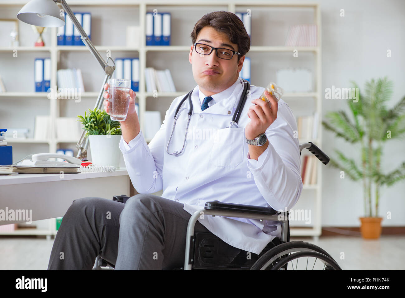 Disabled doctor on wheelchair working in hospital Stock Photo - Alamy