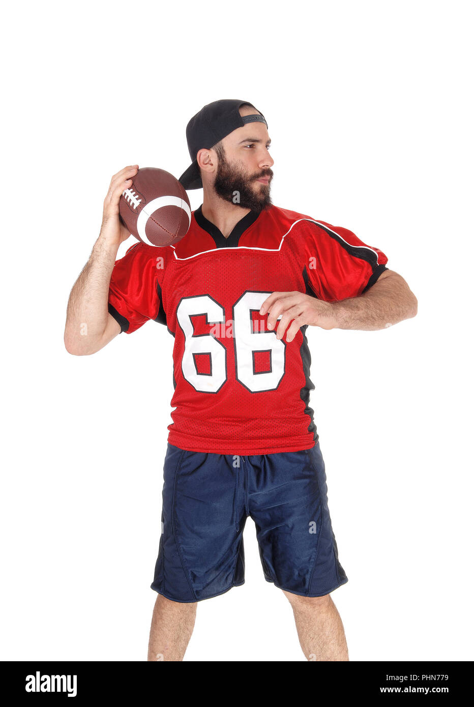 A football player in his jersey throwing the ball Stock Photo - Alamy