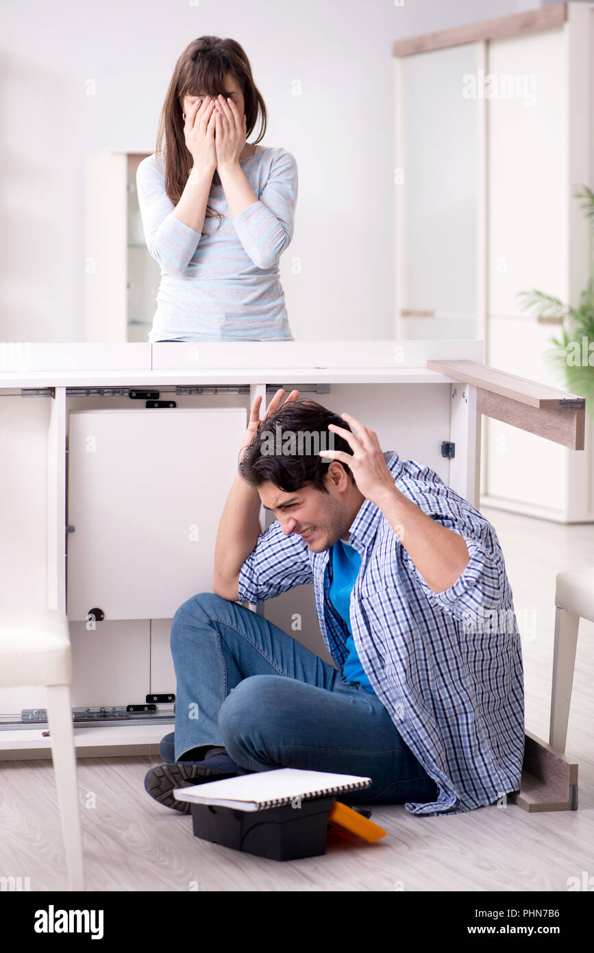 Husband repairing broken table at home Stock Photo - Alamy