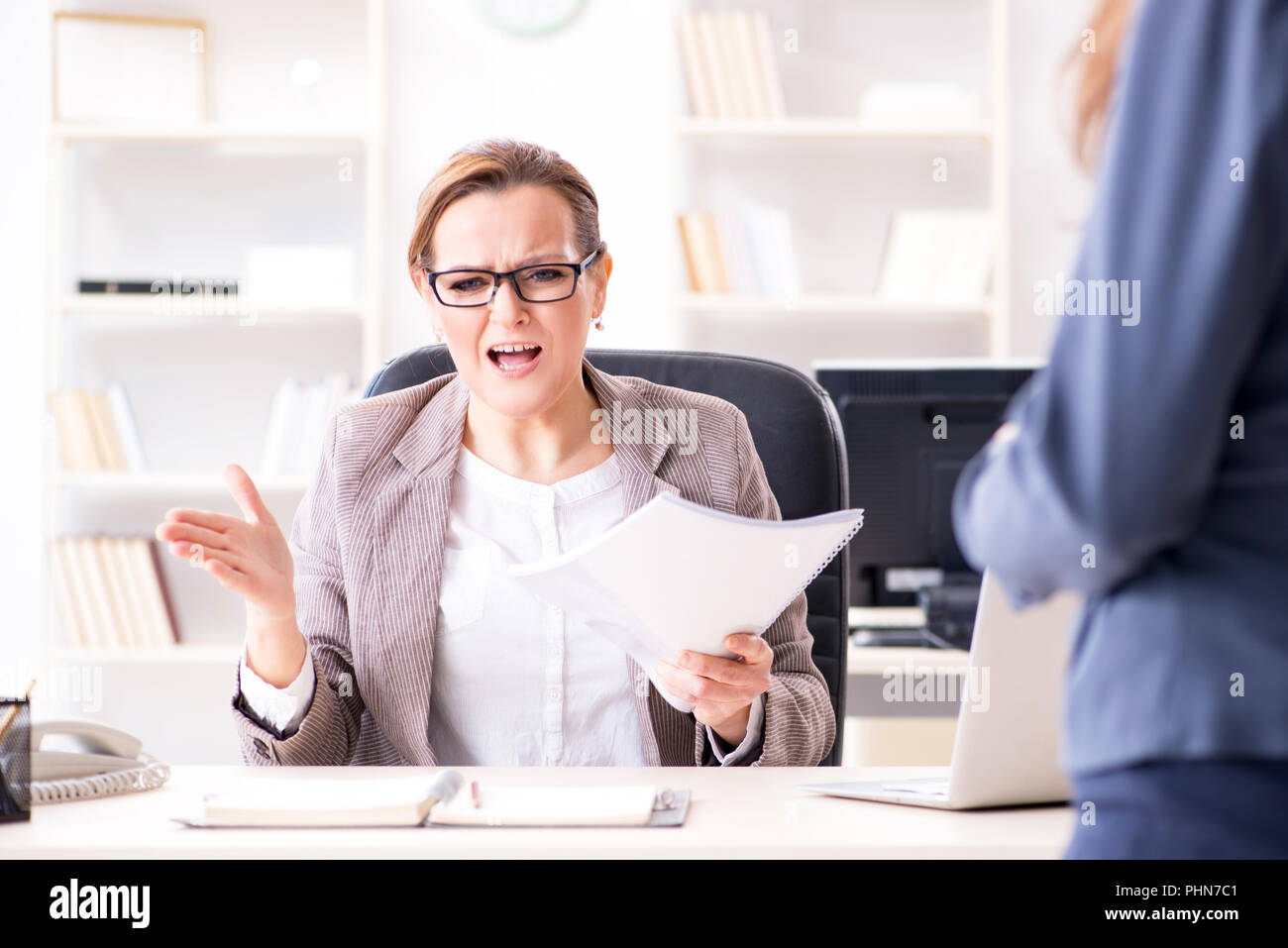 Angry boss dismissing employee for bad underperformance Stock Photo - Alamy