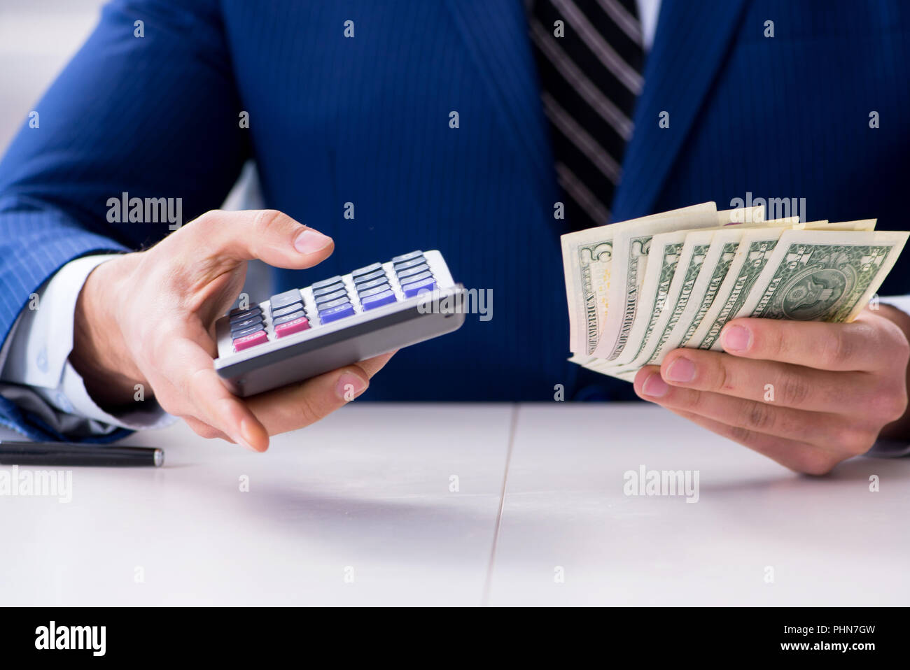 Accountant calculating dollars with calculator in office Stock Photo ...