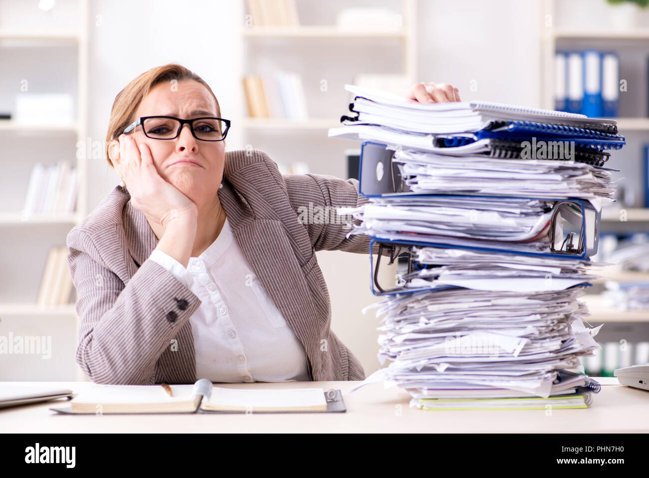 Businesswoman very busy with ongoing paperwork Stock Photo - Alamy