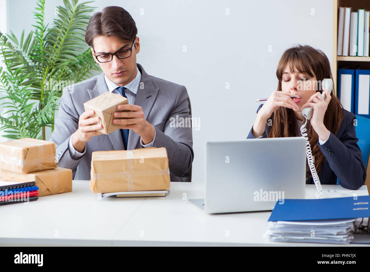 Business people receiving new mail and parcels Stock Photo - Alamy