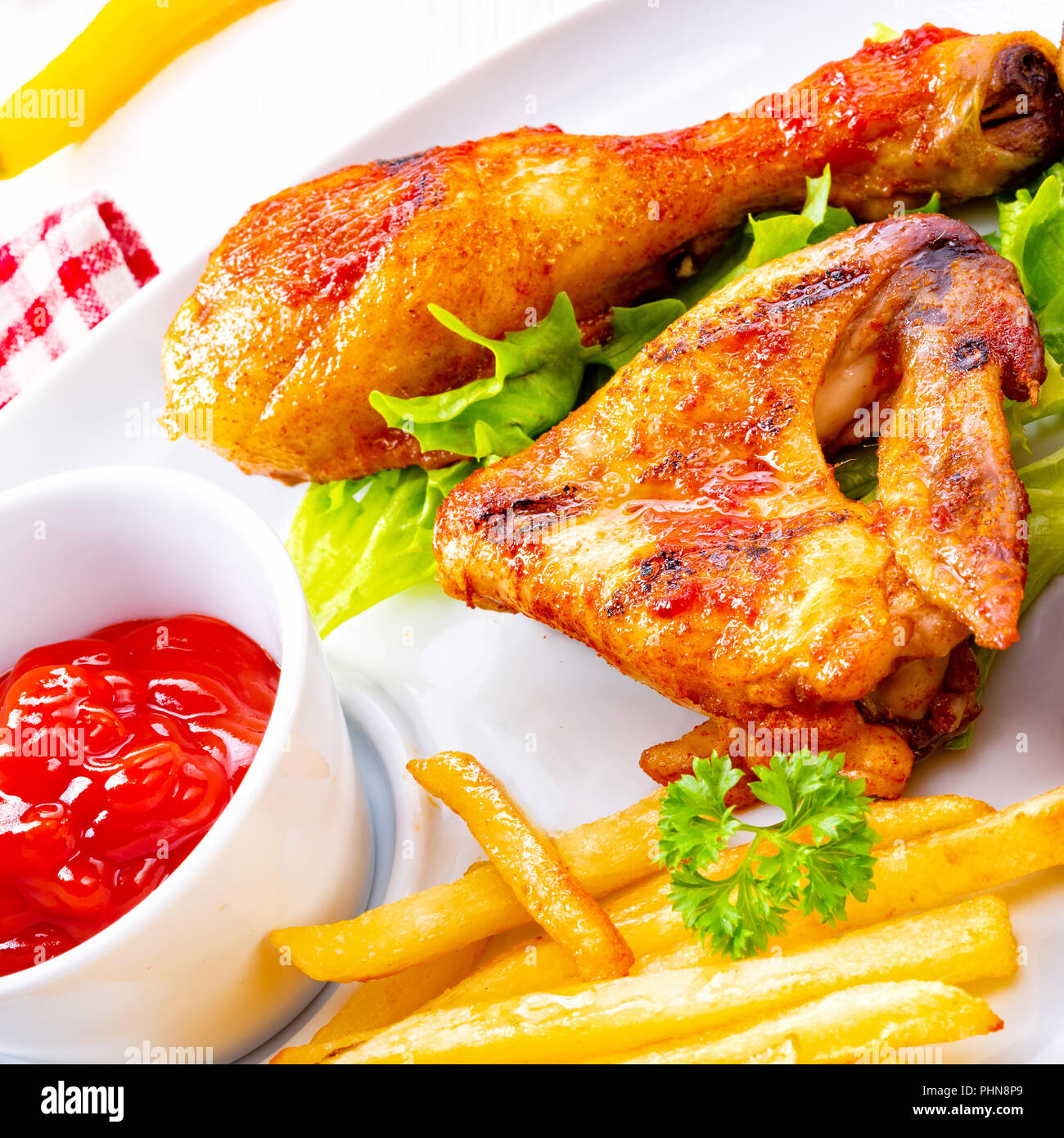 Grilled chicken wings,legs,chips and vegetables Stock Photo - Alamy