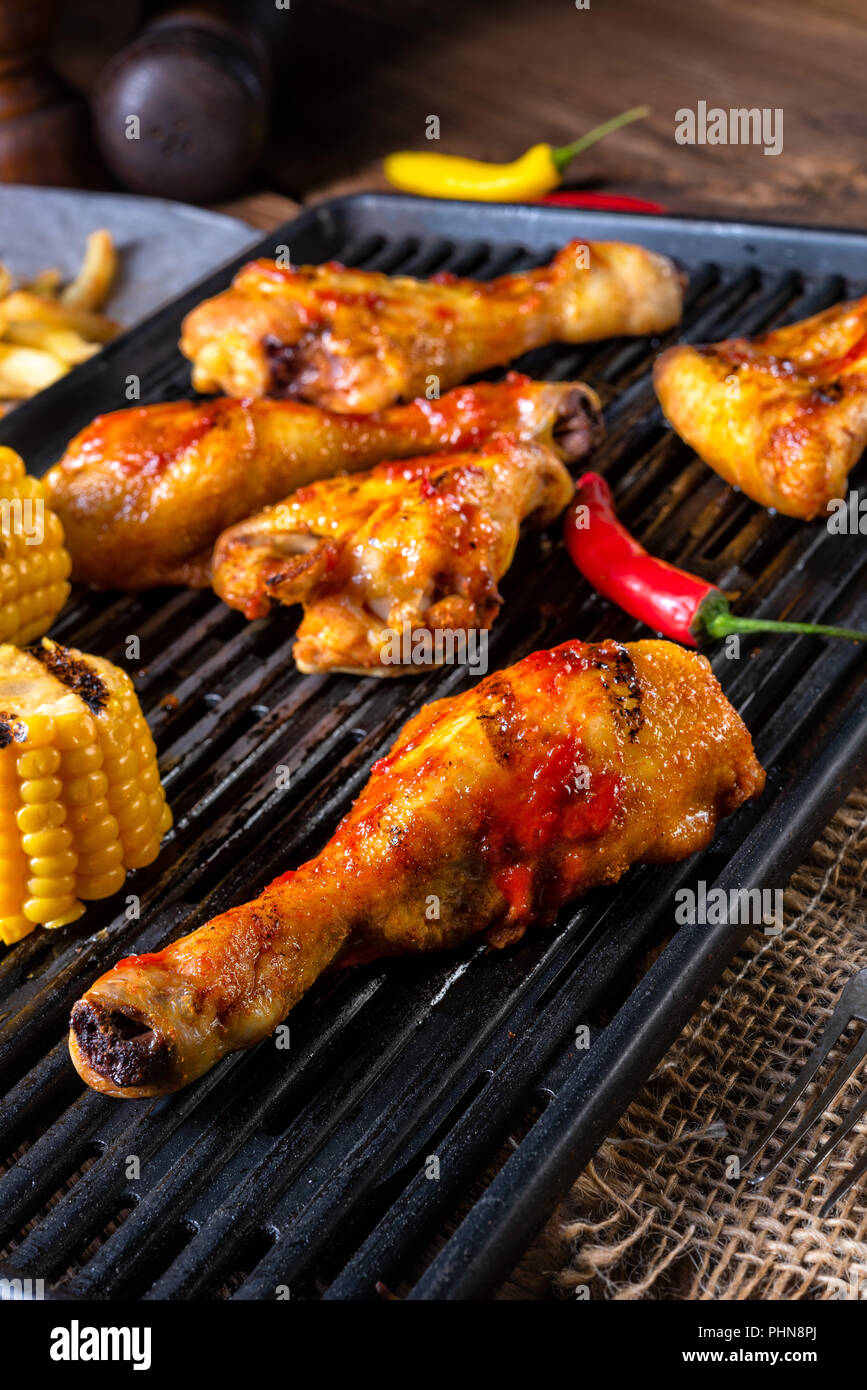 Rustic Grilled chicken wings,legs,and spicy corn Stock Photo - Alamy