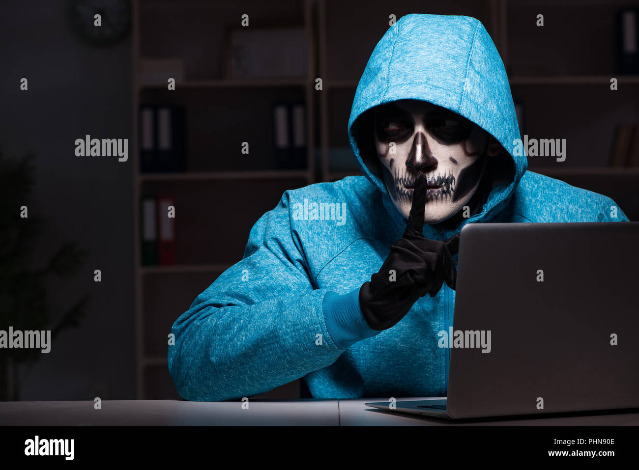 Scary hacker hacking security firewall late in office Stock Photo - Alamy