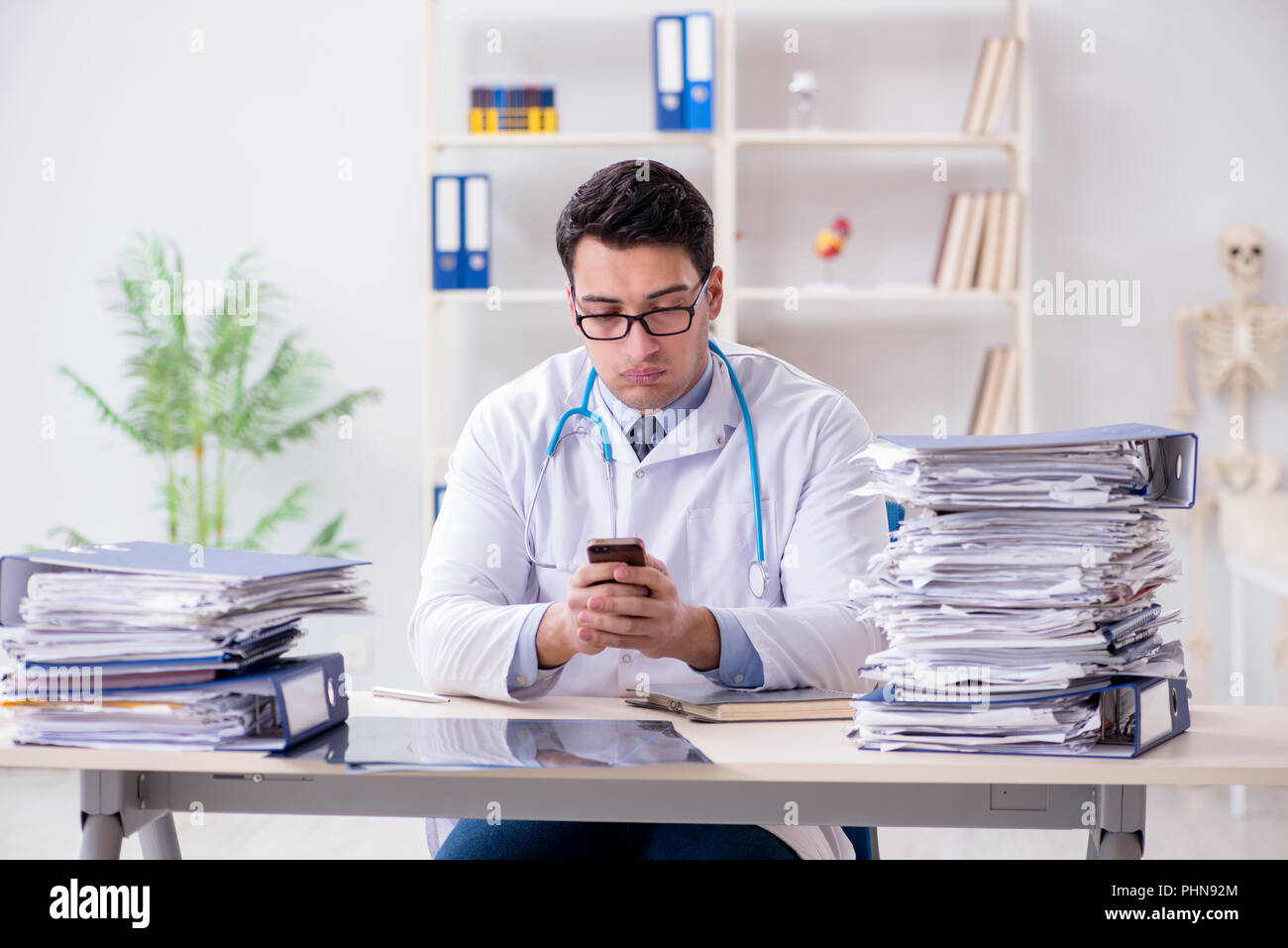 Busy doctor with too much work in hospital Stock Photo - Alamy