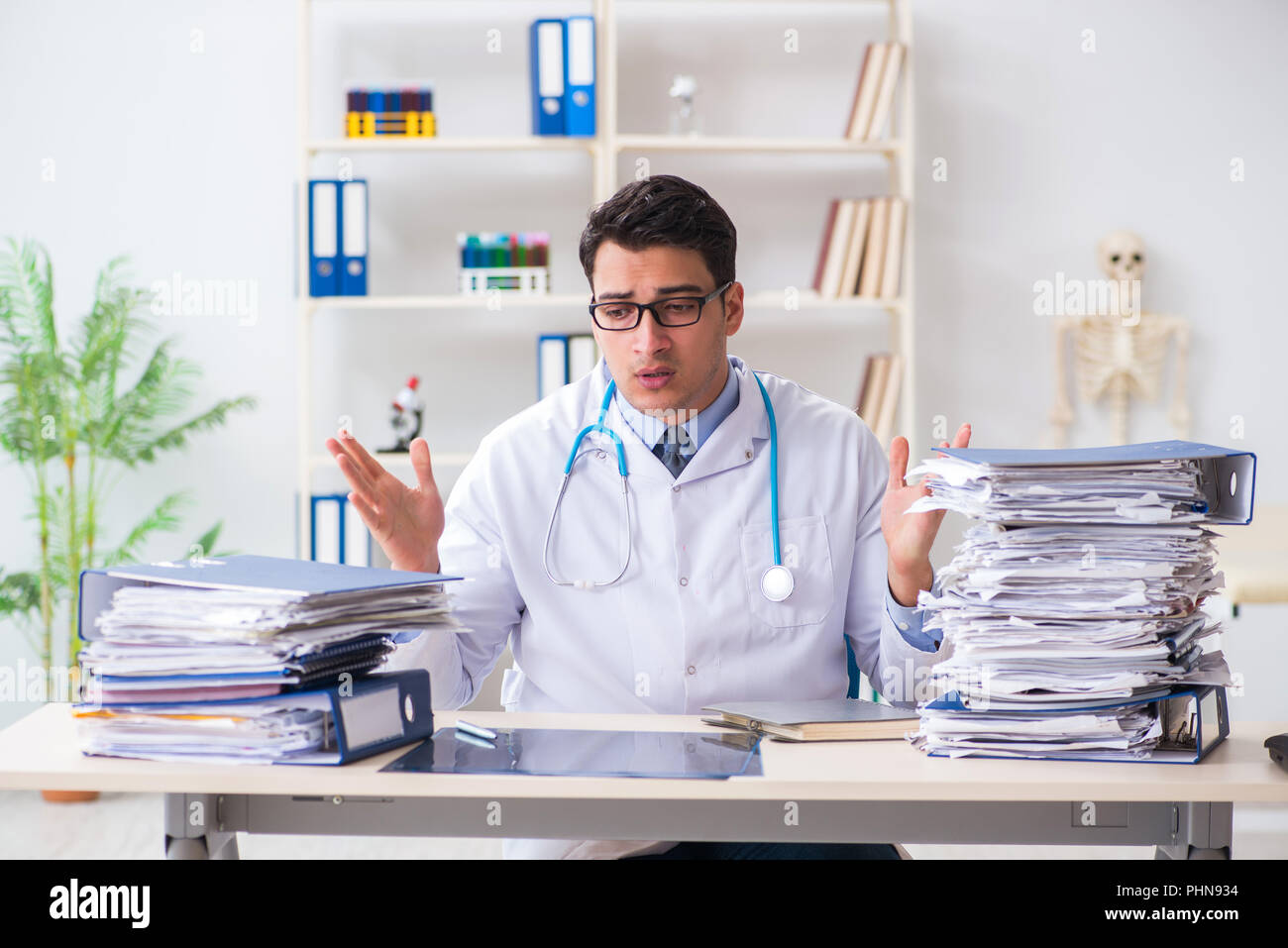 Busy doctor with too much work in hospital Stock Photo - Alamy