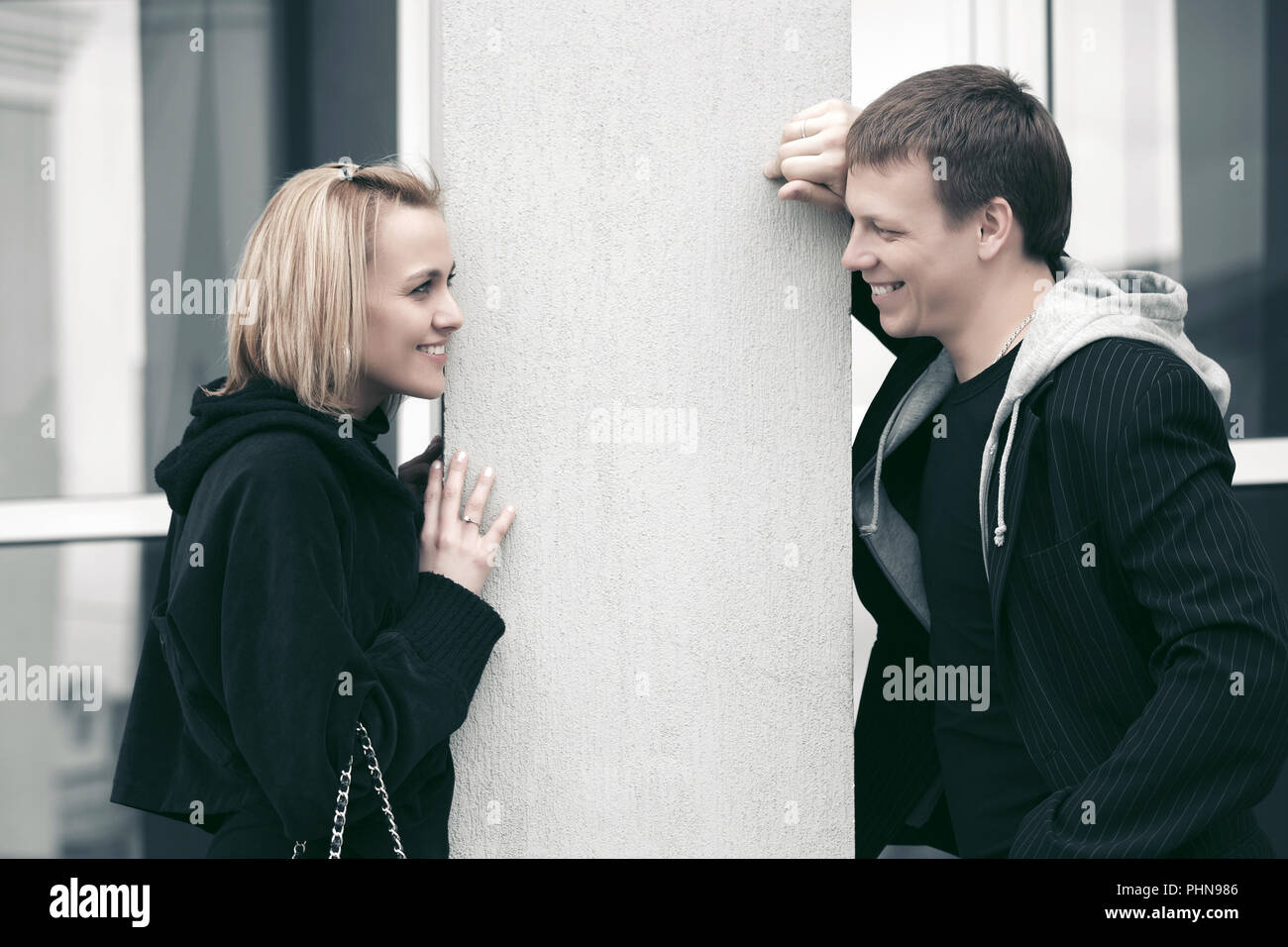 Happy young couple flirting in city street Stock Photo - Alamy