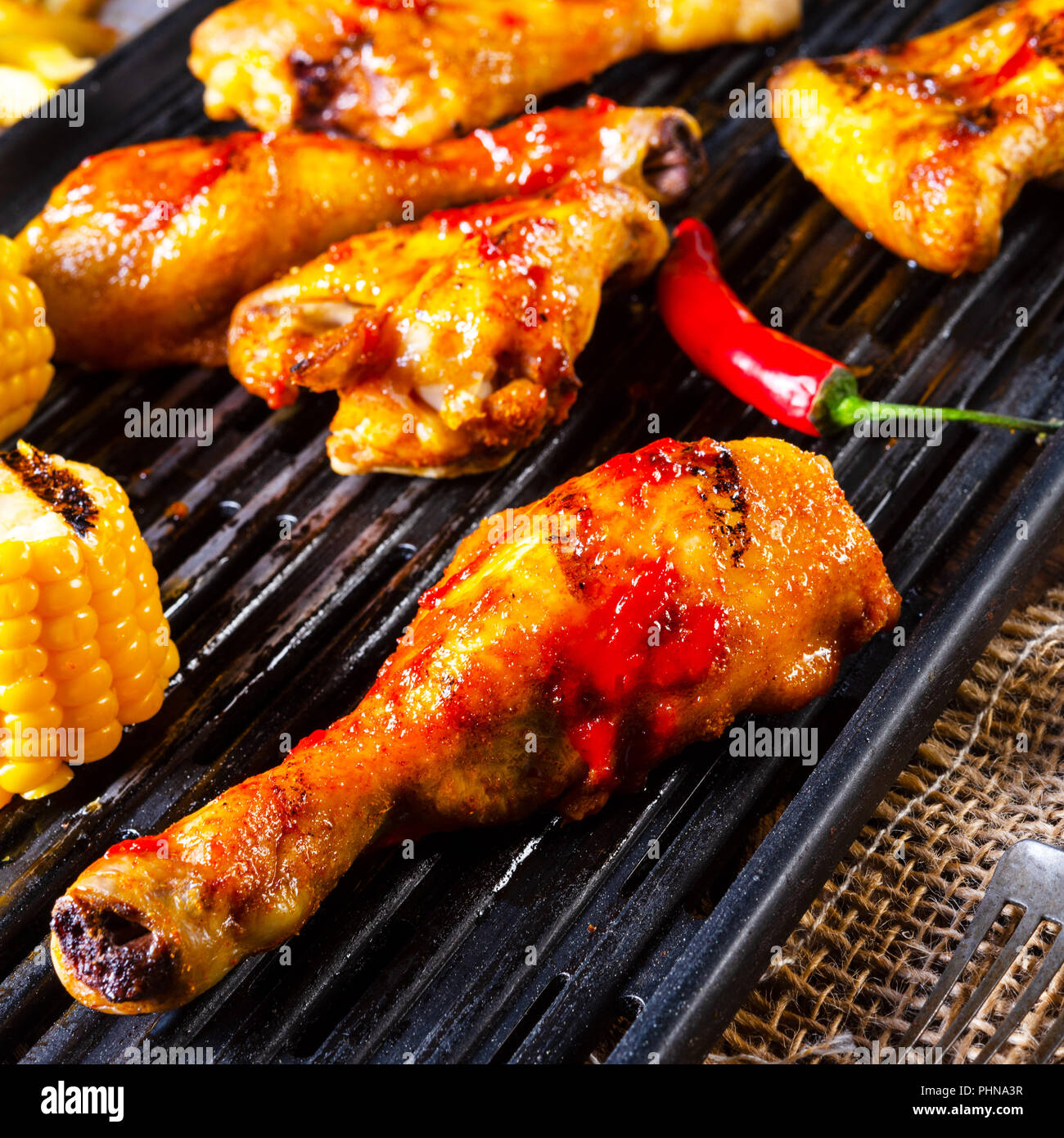 Rustic Grilled chicken wings,legs,and spicy corn Stock Photo - Alamy