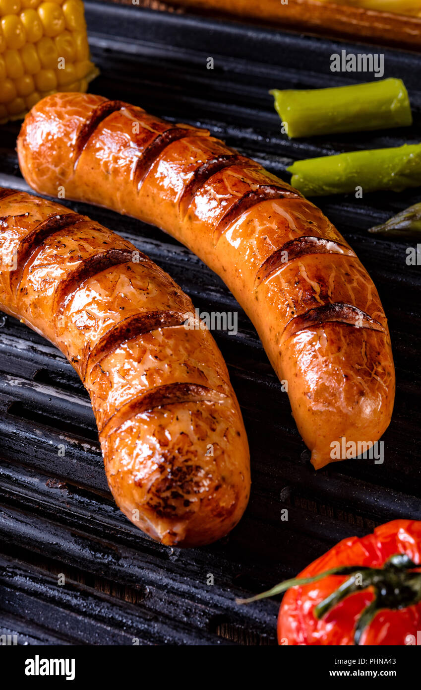 grilled krakauer with french fries and green salad Stock Photo - Alamy
