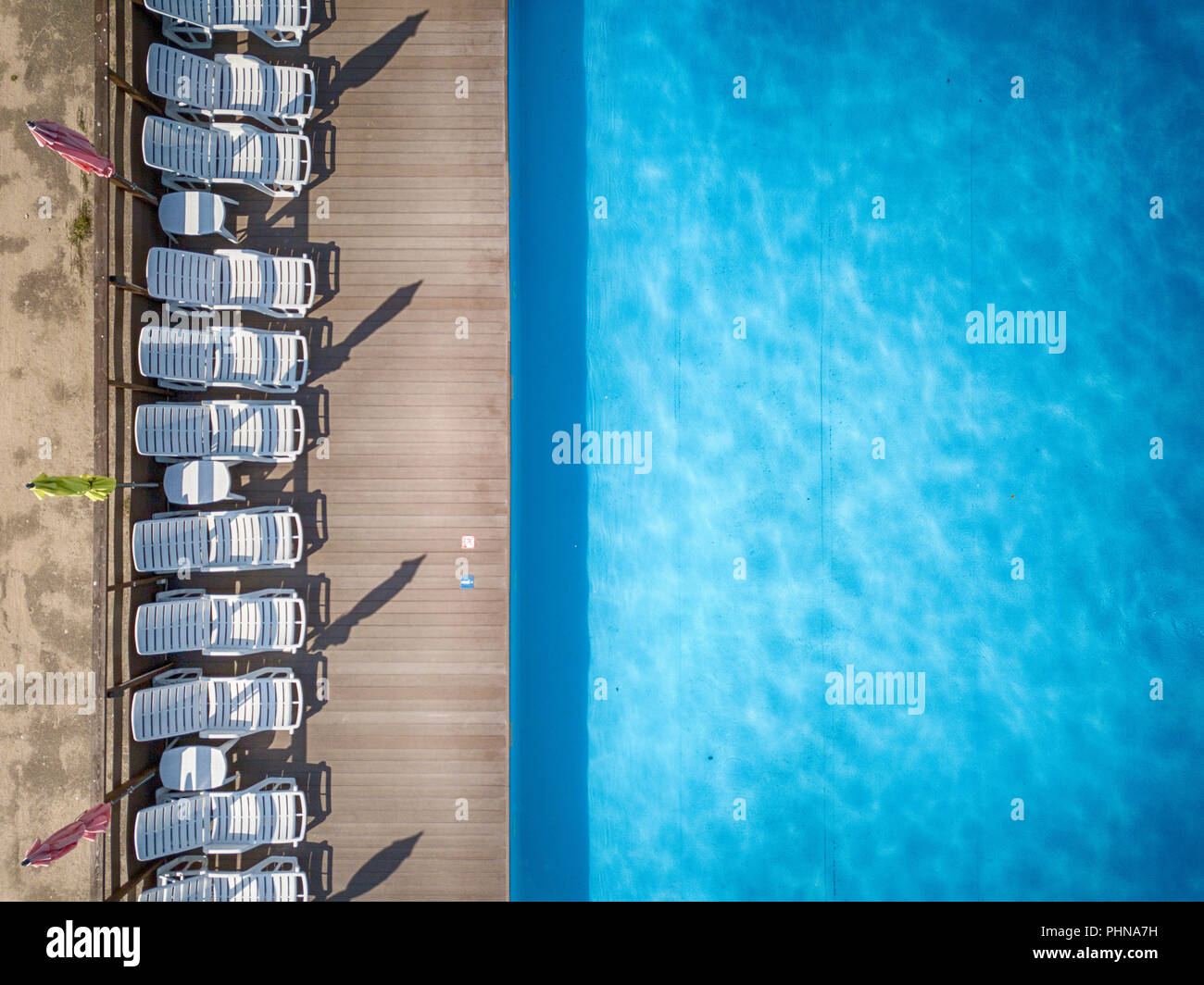 Beach chairs near swimming pool, top view Stock Photo - Alamy