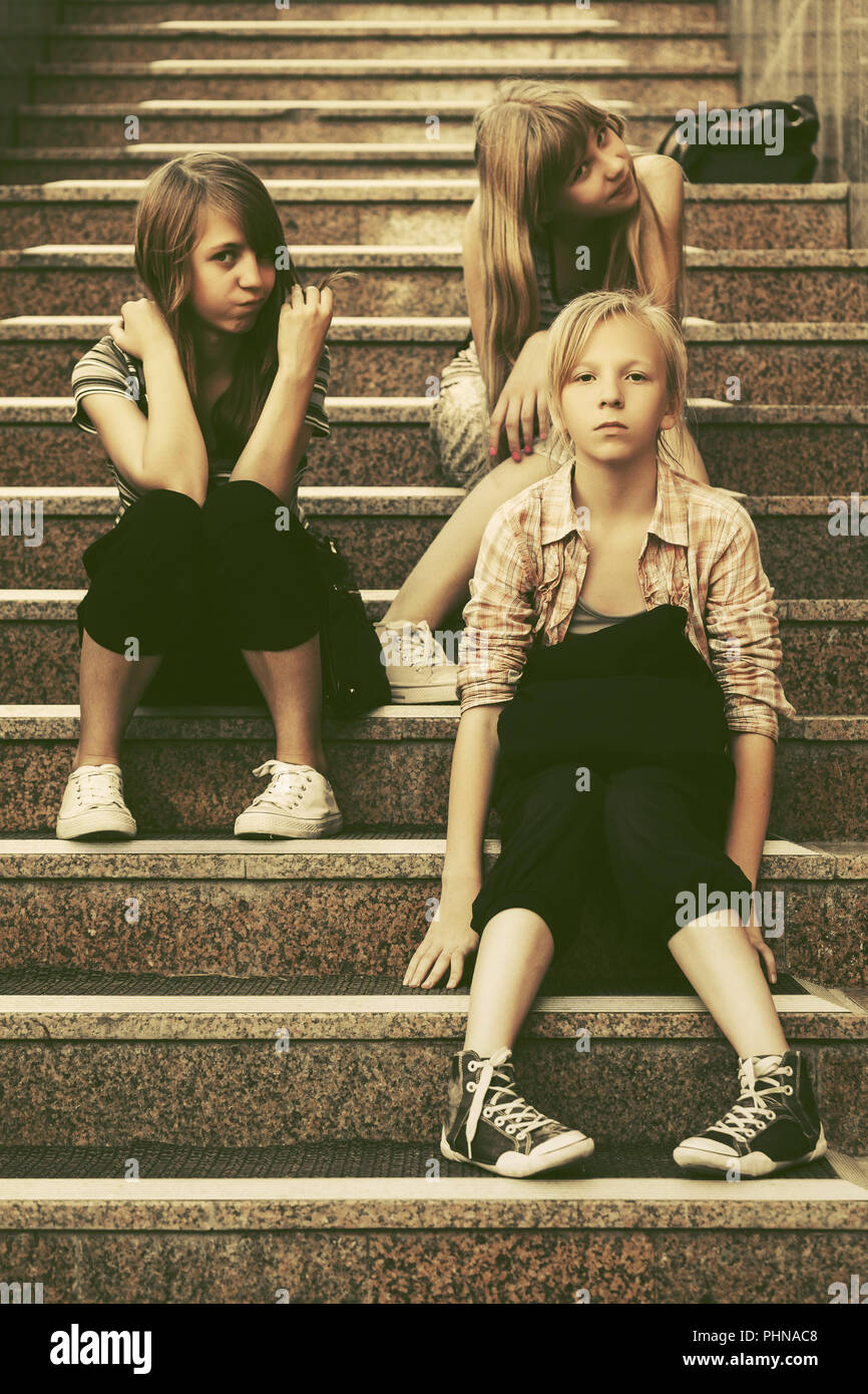 Group of happy fashion teen girls sitting on steps Stock Photo - Alamy