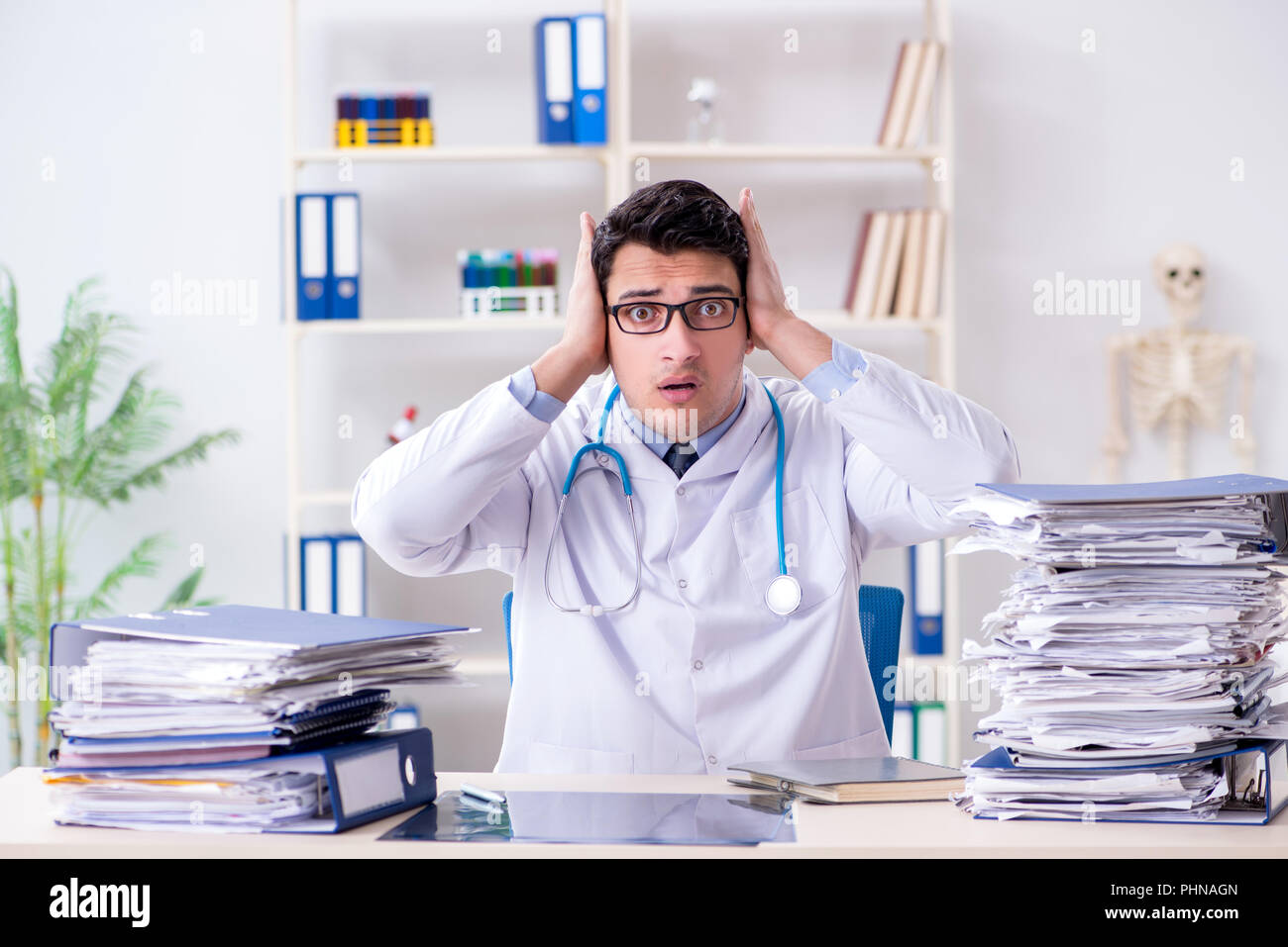 Busy doctor with too much work in hospital Stock Photo - Alamy