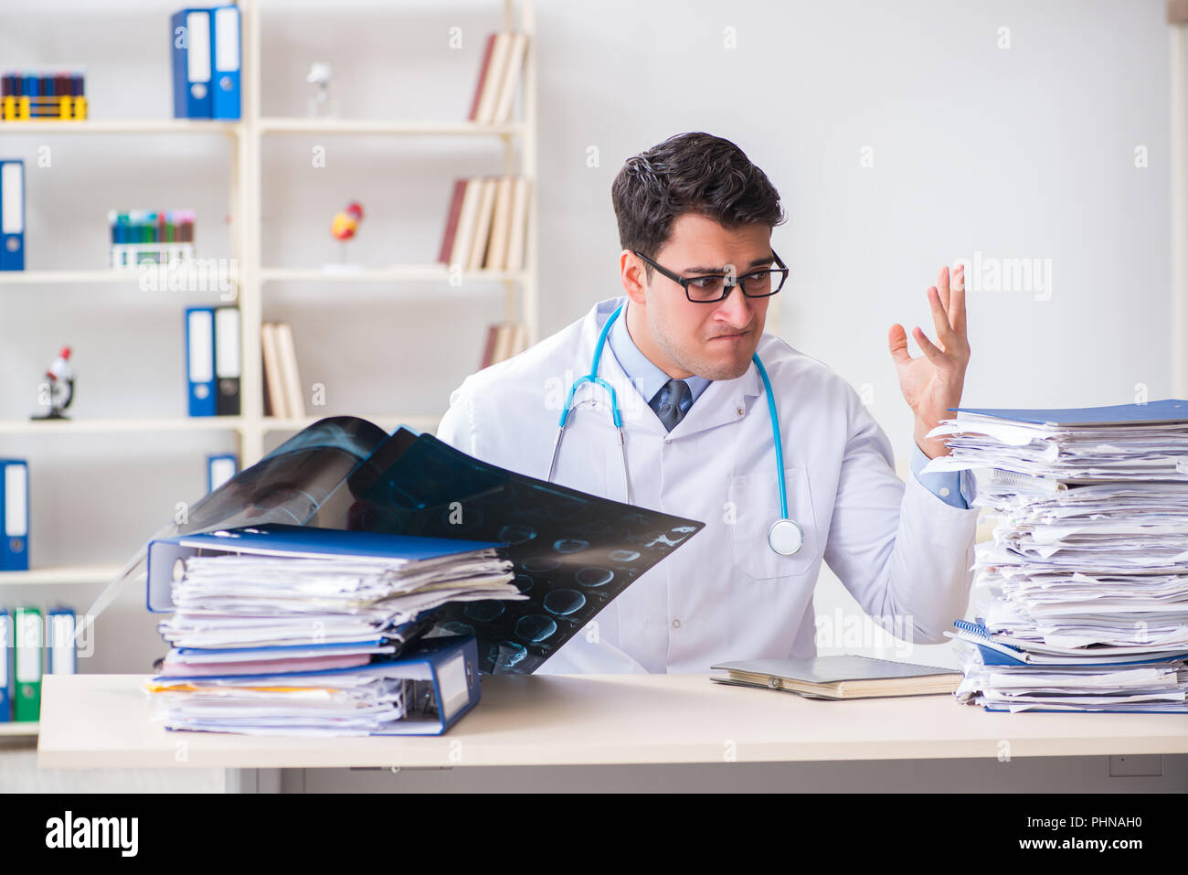 Tired radiologist with x-ray image in hospital Stock Photo - Alamy