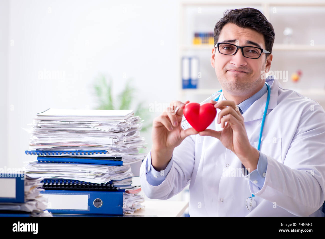 Busy doctor with too much work in hospital Stock Photo - Alamy
