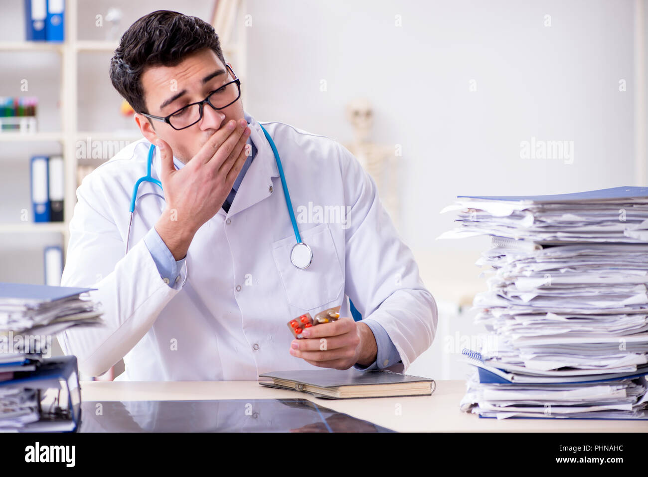 Busy doctor with too much work in hospital Stock Photo - Alamy