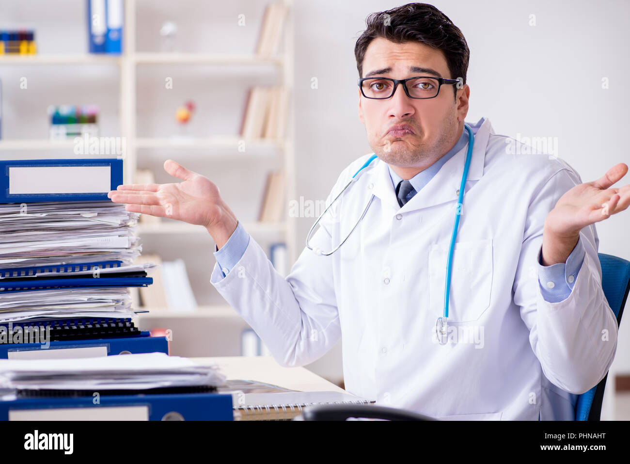 Busy doctor with too much work in hospital Stock Photo - Alamy
