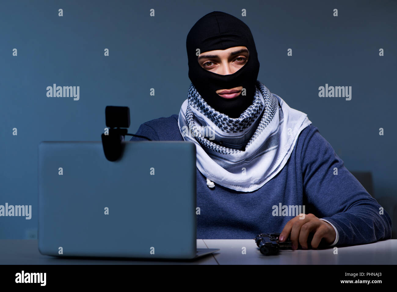 Hacker wearing balaclava mask hacking computer Stock Photo - Alamy