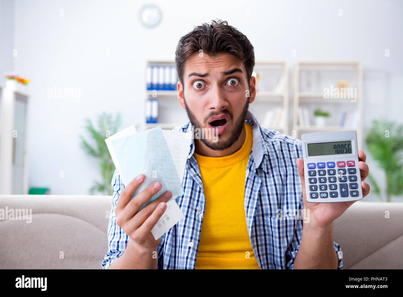 Man angry at bills he needs to pay Stock Photo - Alamy