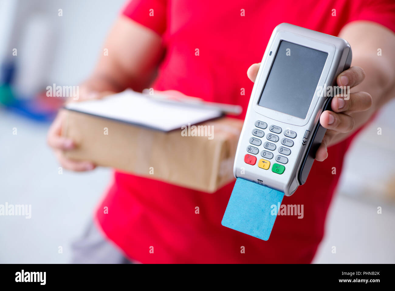 Parcel delivery being paid with pos and credit card Stock Photo - Alamy