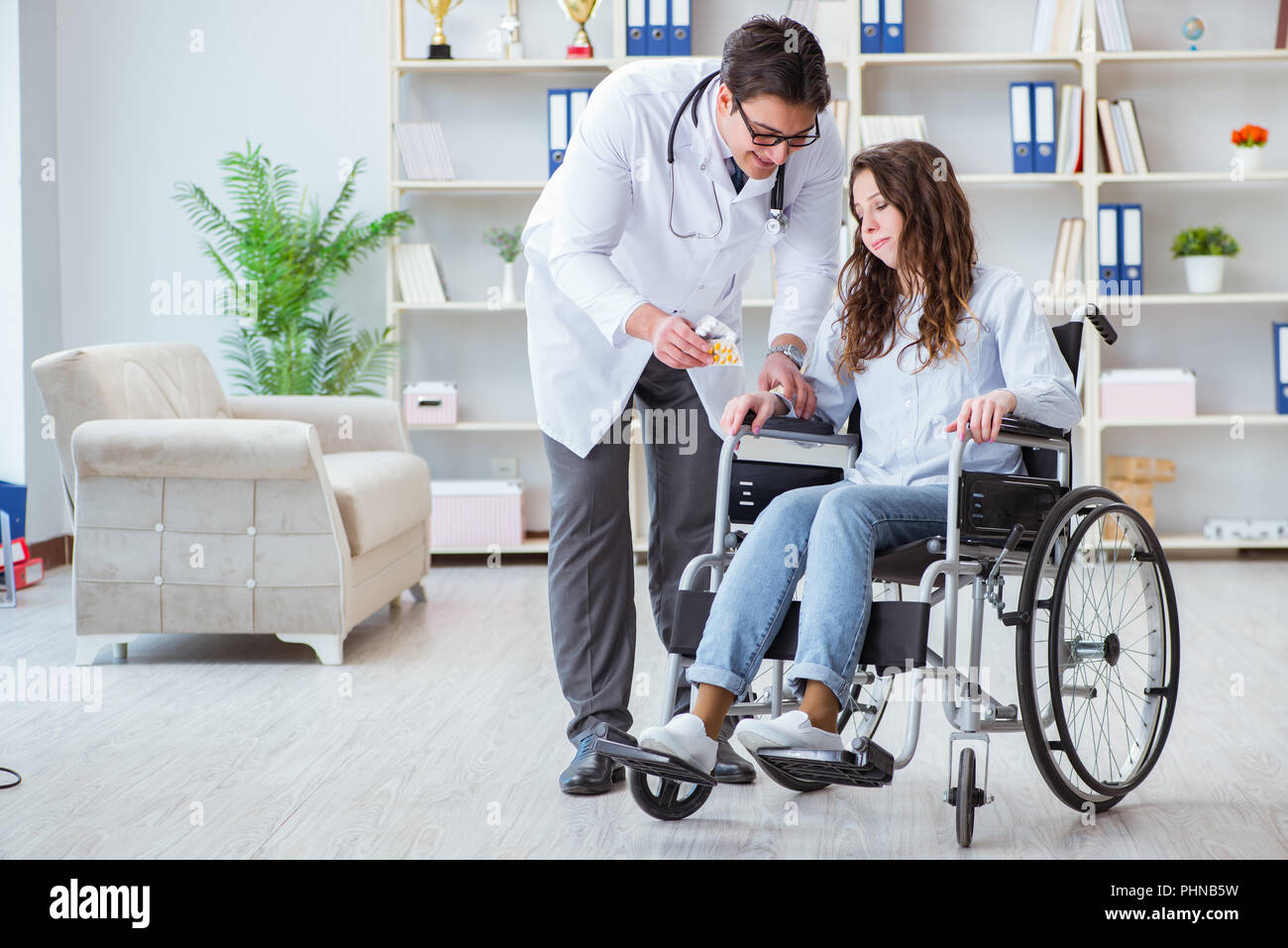 Disabled patient on wheelchair visiting doctor for regular check Stock ...