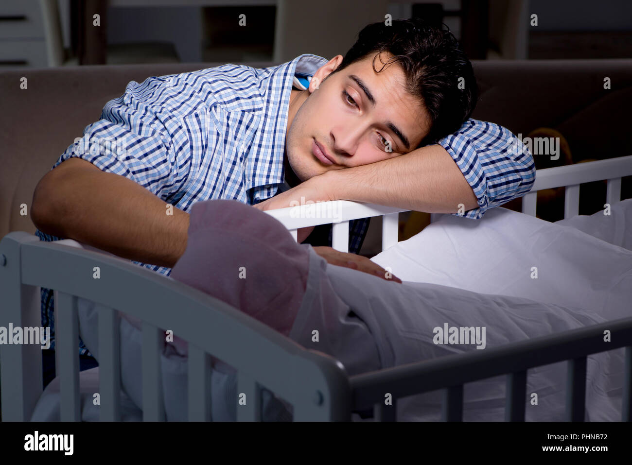 Young father dad sleeping while looking after newborn baby Stock Photo ...