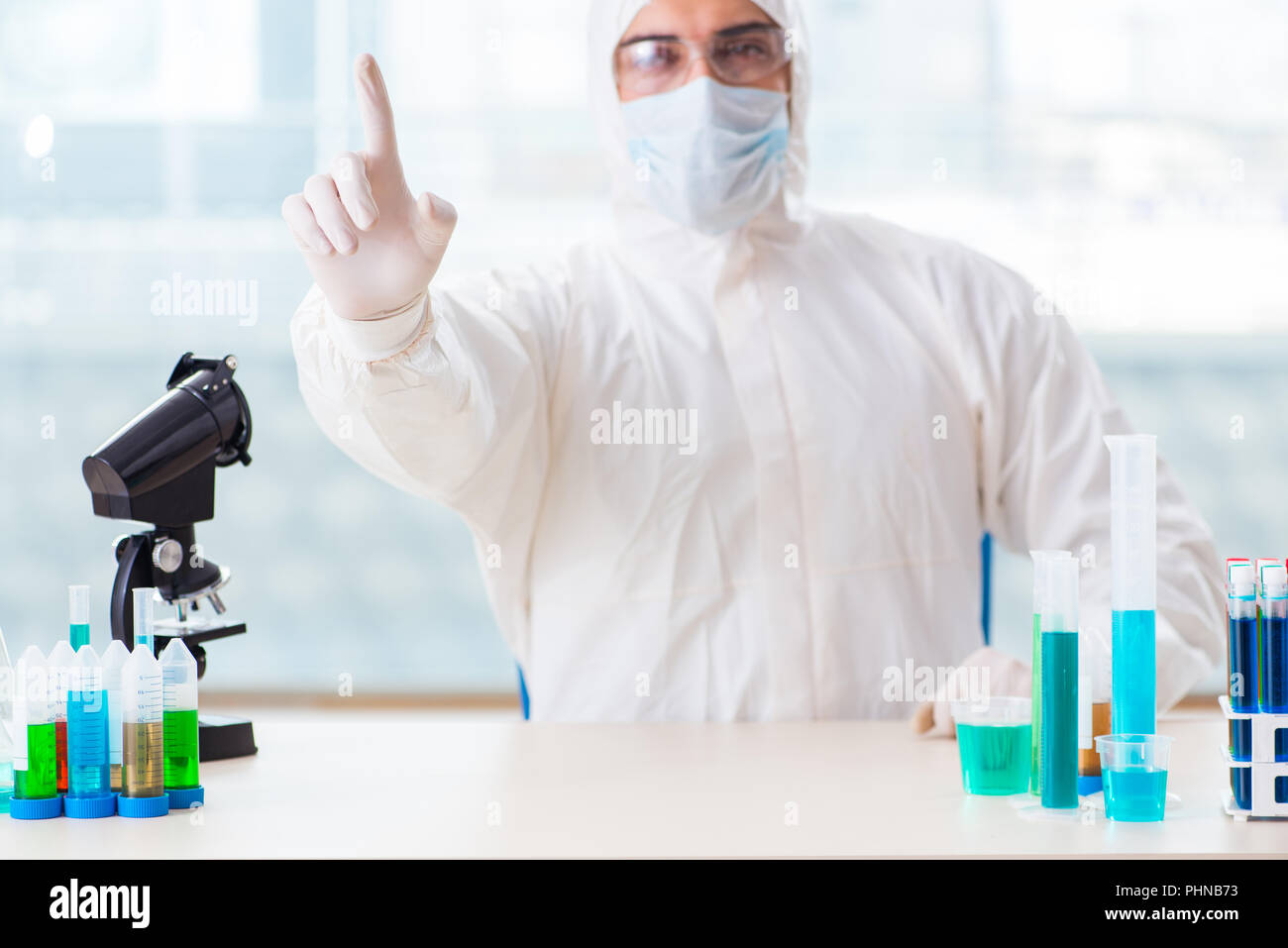 Young chemist pressing virtual buttons in lab Stock Photo - Alamy