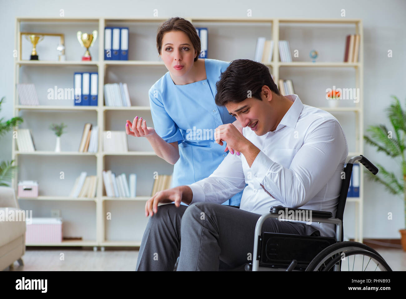 Disabled patient on wheelchair visiting doctor for regular check Stock ...