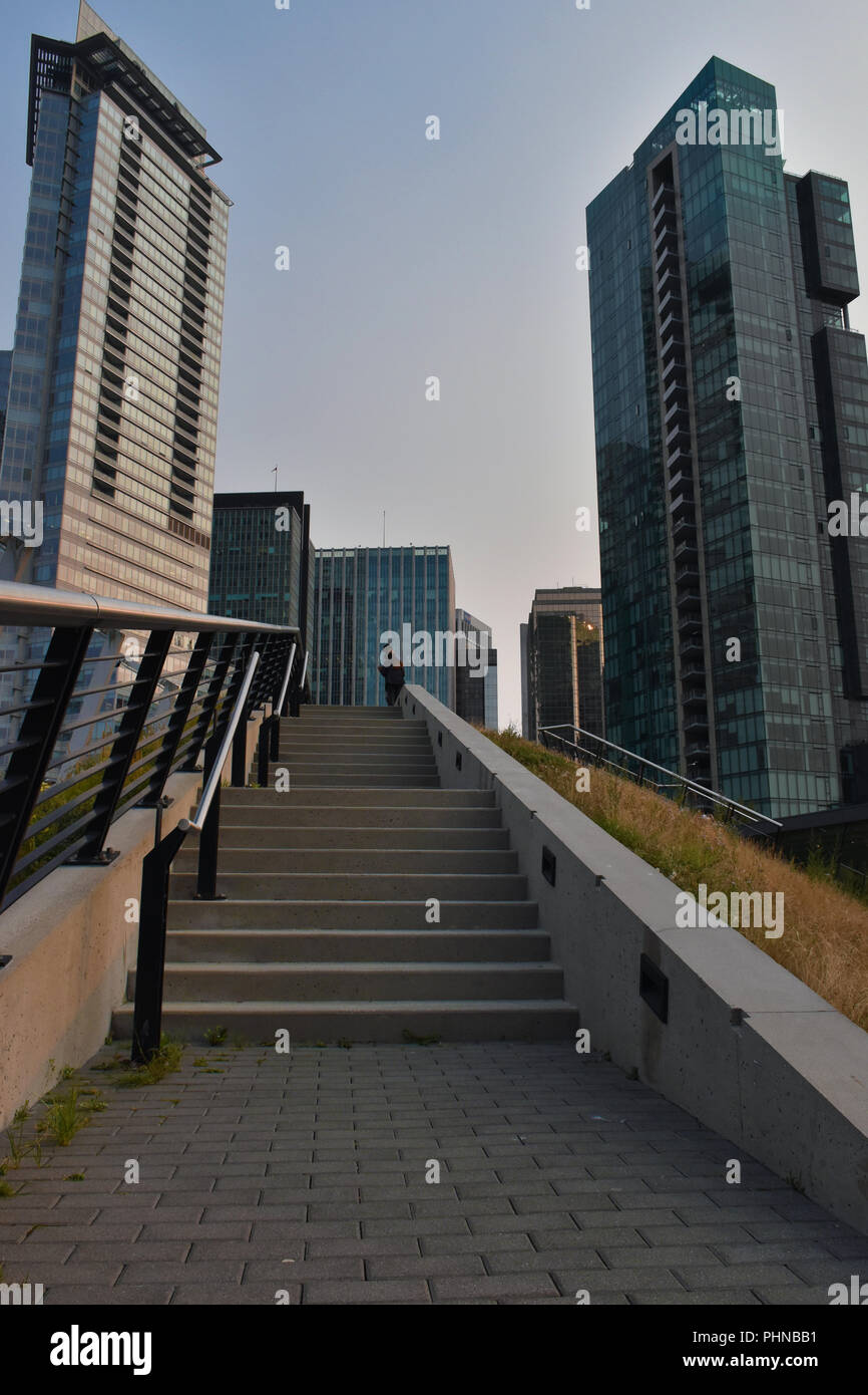 Looking up the stairs to see Skyscrapers towering Stock Photo - Alamy
