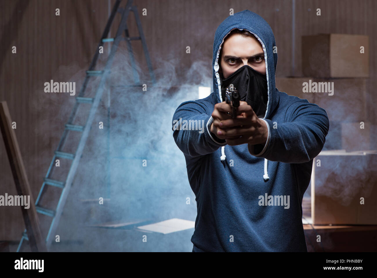 Aggressive manwith gun wearing face mask Stock Photo - Alamy