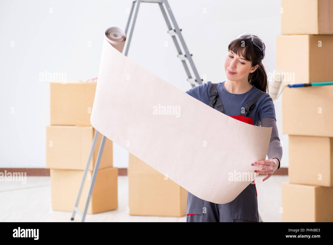 Woman preparing for wallpaper work Stock Photo - Alamy