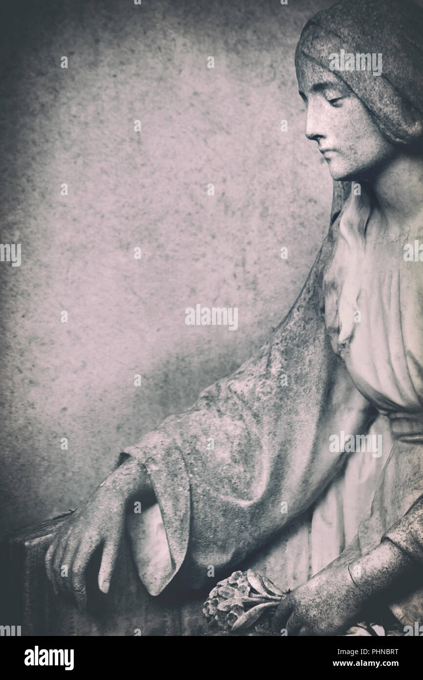 portrait of a weathered stone maria sculpture Stock Photo - Alamy
