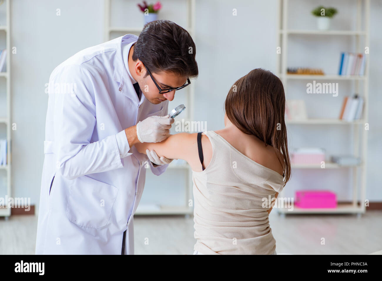 Doctor examining the skin of female patient Stock Photo - Alamy