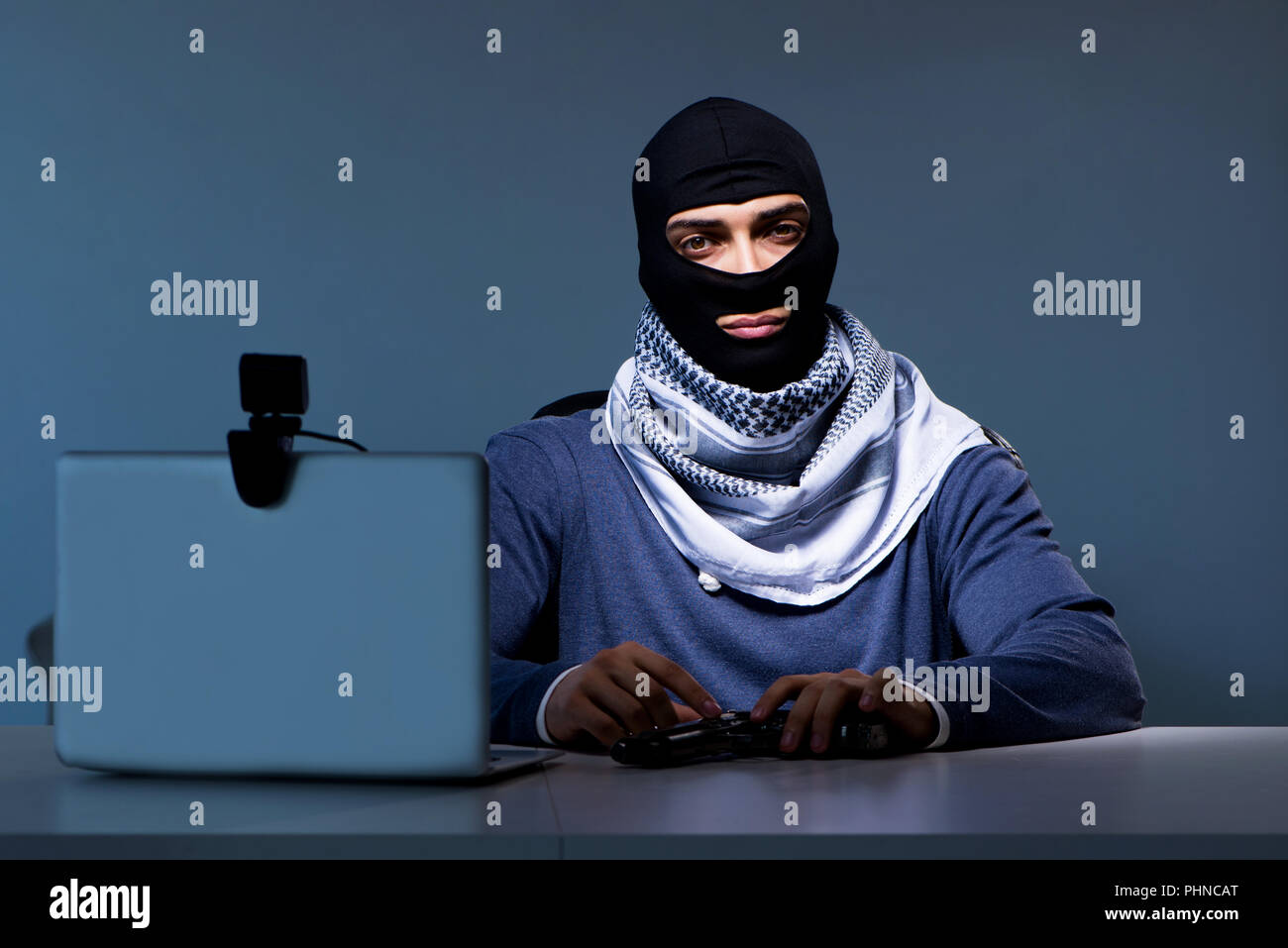 Hacker wearing balaclava mask hacking computer Stock Photo - Alamy
