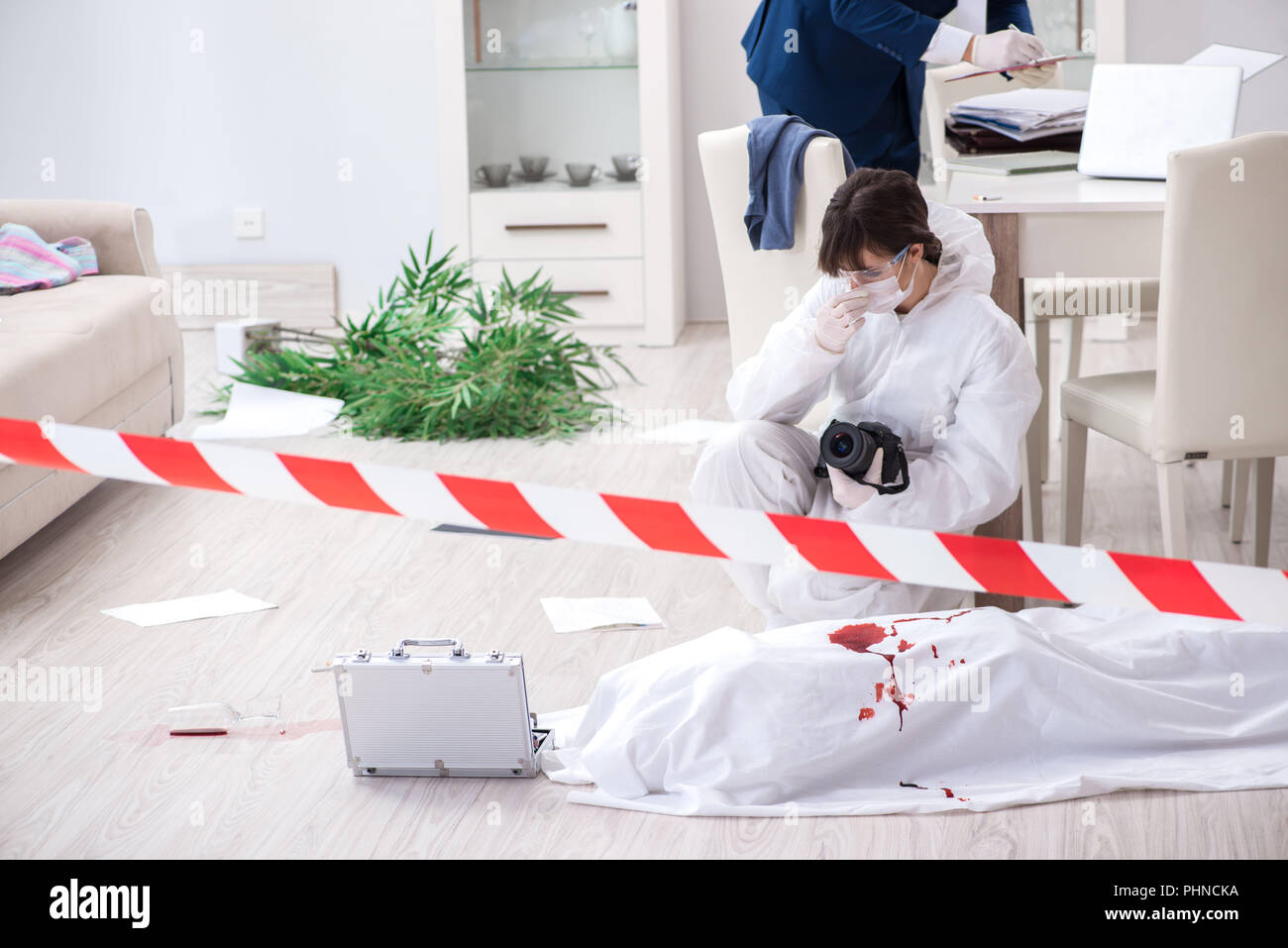 Forensics investigator at the scene of office crime Stock Photo - Alamy